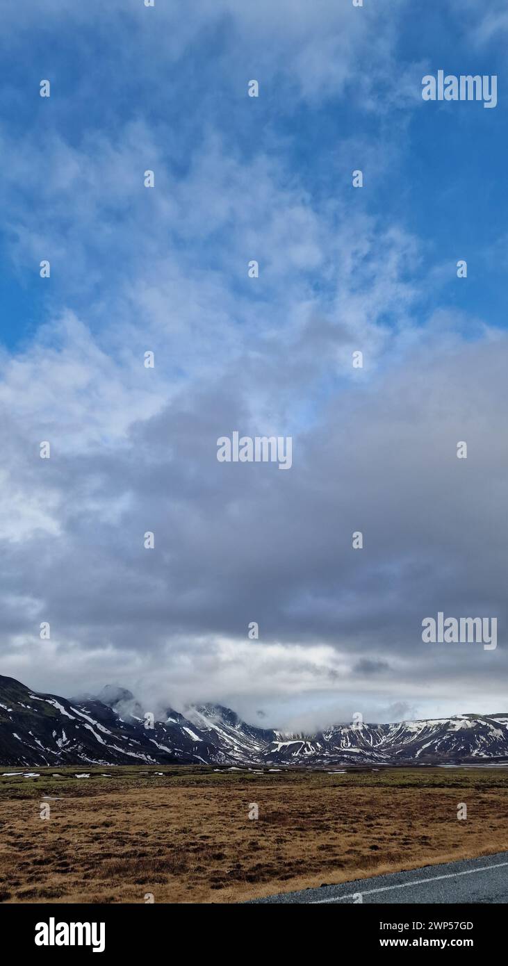 Majestic long road scenery in arctic countryside with fields and snowy ...