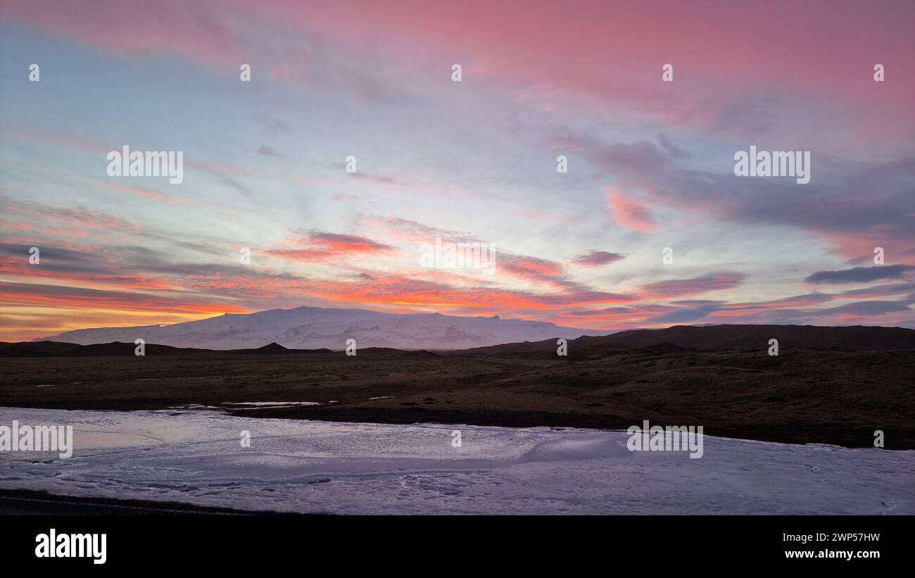 Amazing pink sky during sunset in iceland, covering frosty mountains ...