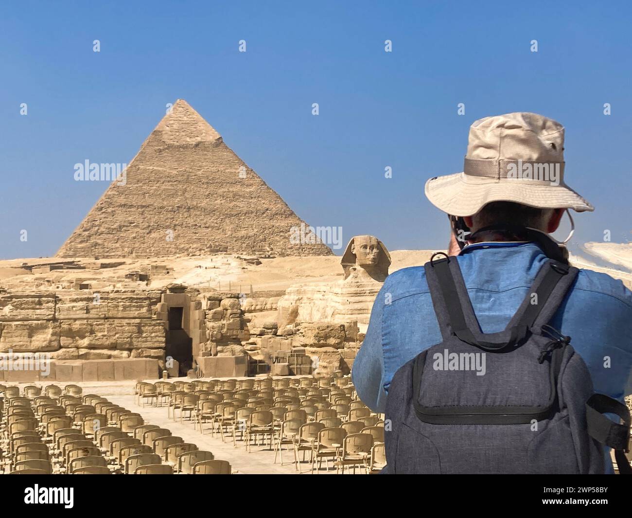 Tourist with hat photographing a pyramid in Egypt with his camera Stock ...