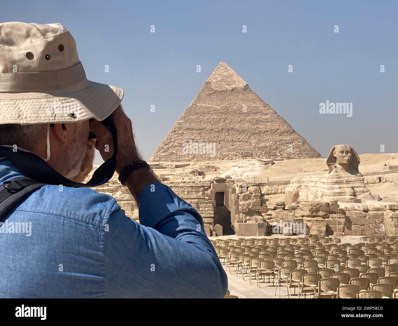 Tourist with hat photographing a pyramid in Egypt with his camera Stock ...