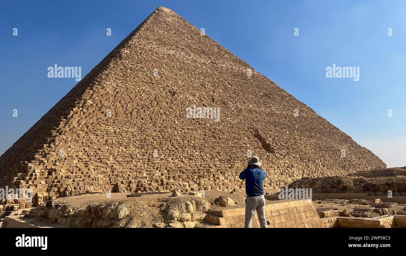 Tourist with hat photographing a pyramid in Egypt with his camera Stock ...