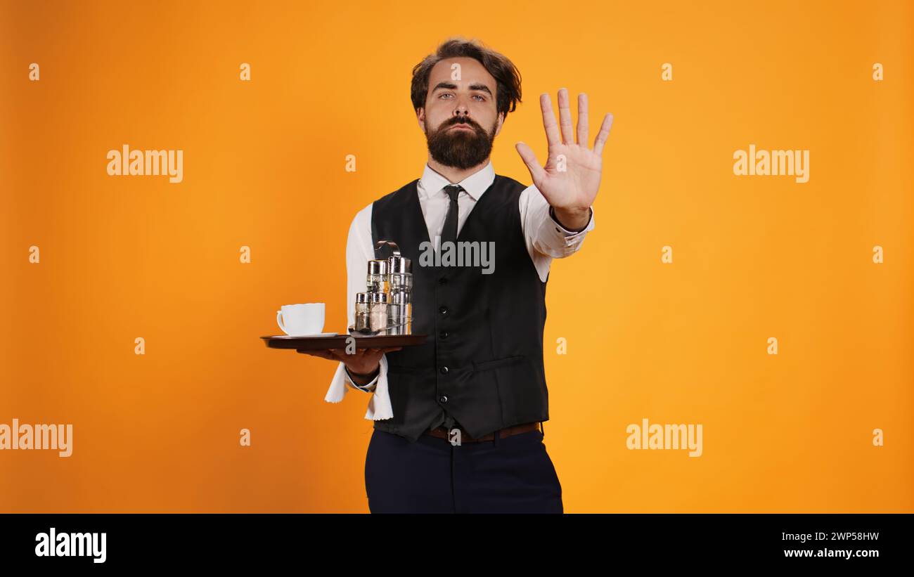 Butler indicates stop sign palm hi-res stock photography and images - Alamy