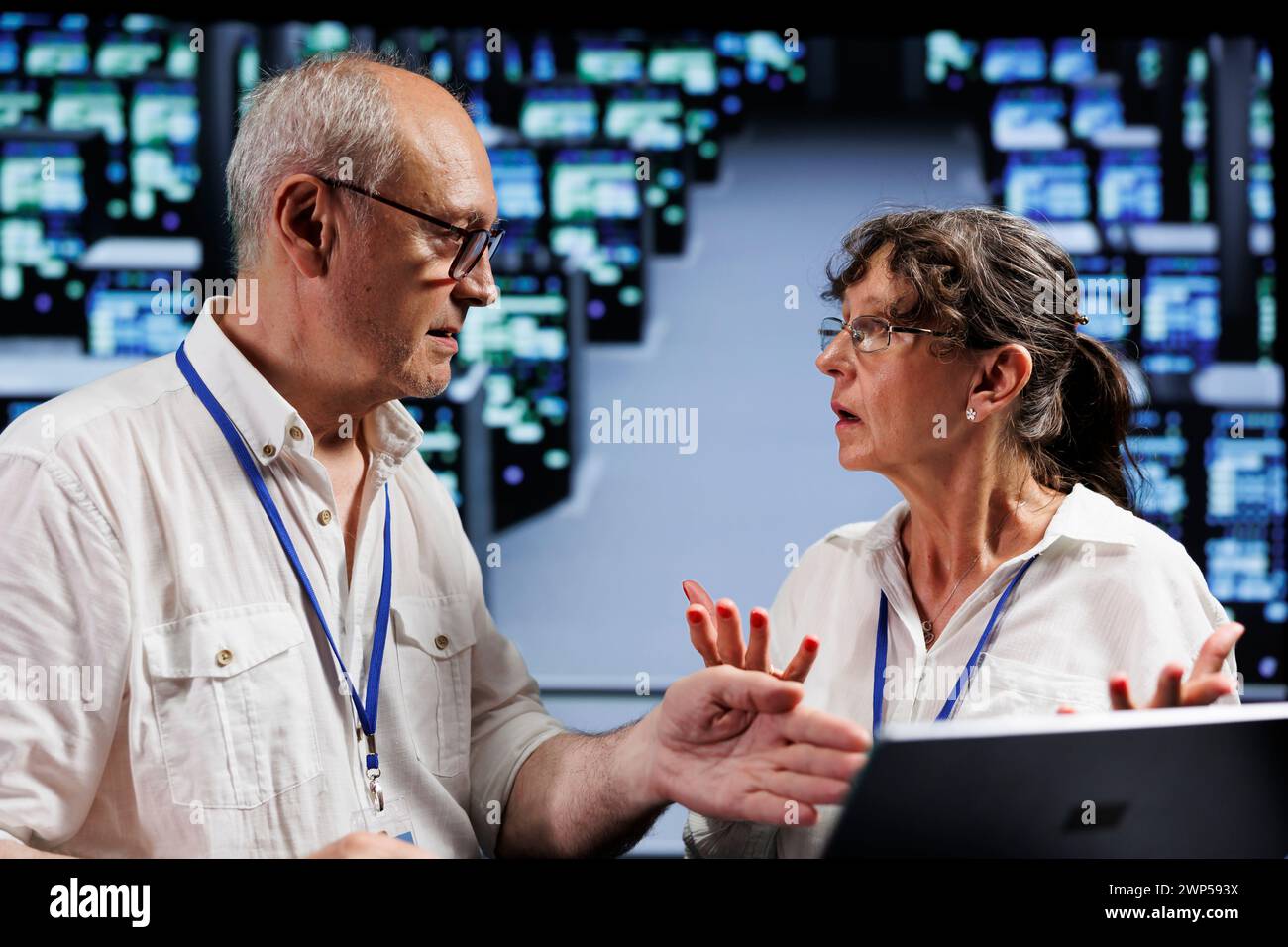 Octogenarian employees working to maintain uptime in high tech workspace. Efficient workers ...