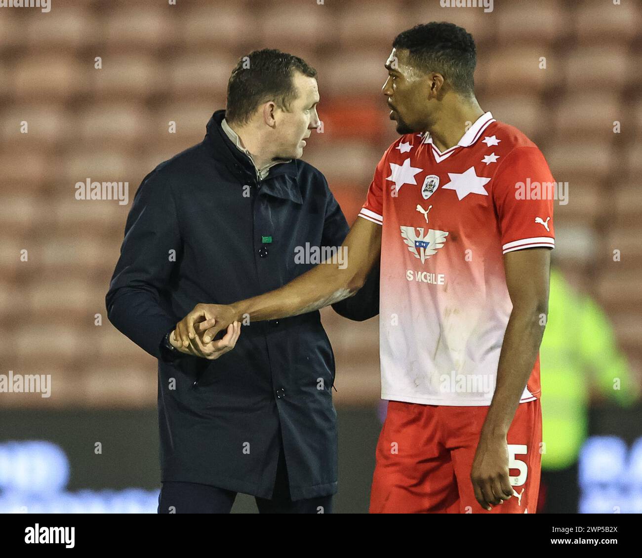 Neill Collins Head coach of Barnsley shakes hands with Donovan Pines of ...