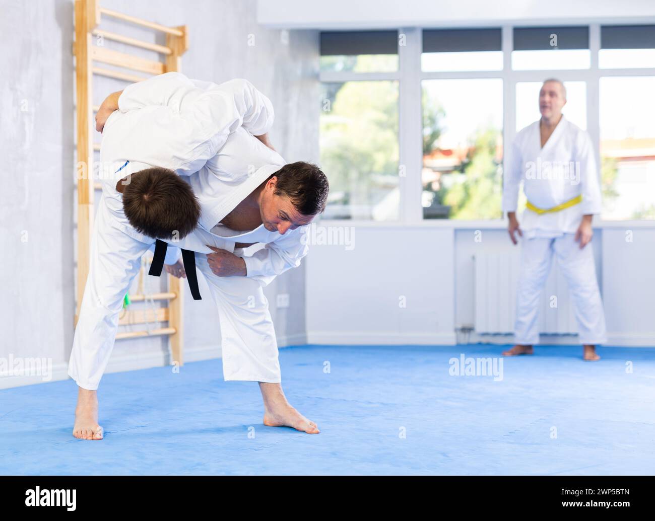 Experienced karate instructor demonstrating techniques in sparring with ...