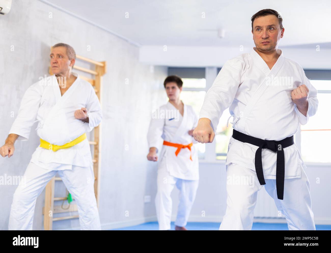 Man in white kimono performing kata routines at martial arts training ...