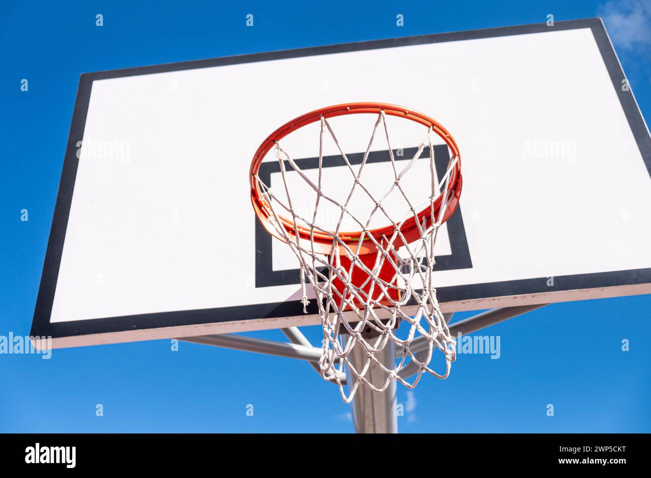 view of basketball hoop seen from below on a blue sky background Stock ...