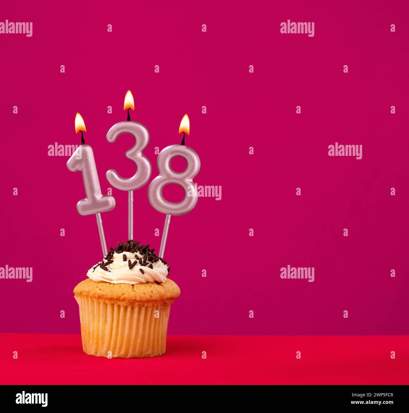 Candle number 138 - cupcake birthday in rhodamine red background Stock ...