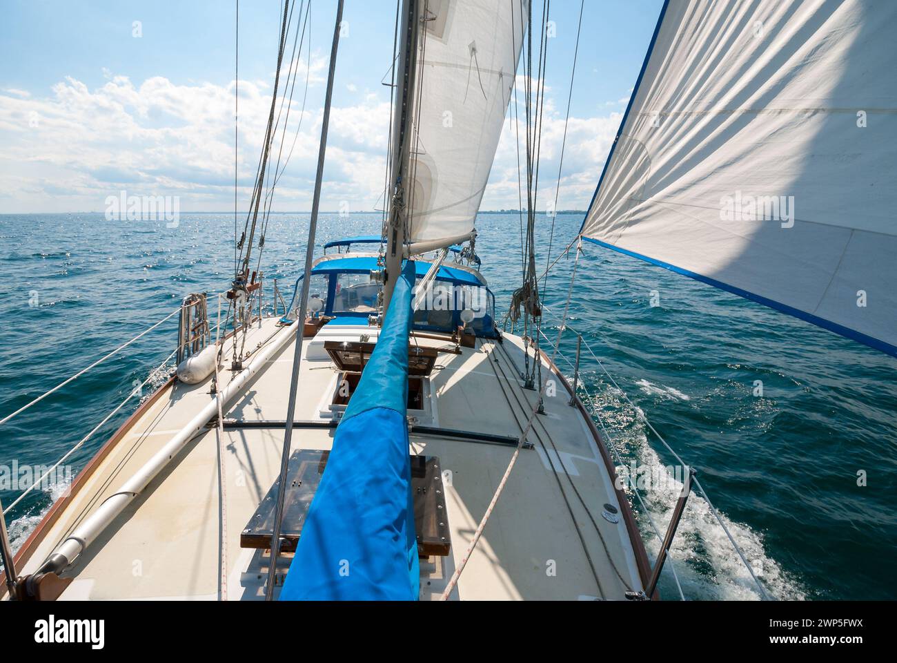 A view from the bow of the deck and rigging of a recreational sailboat ...