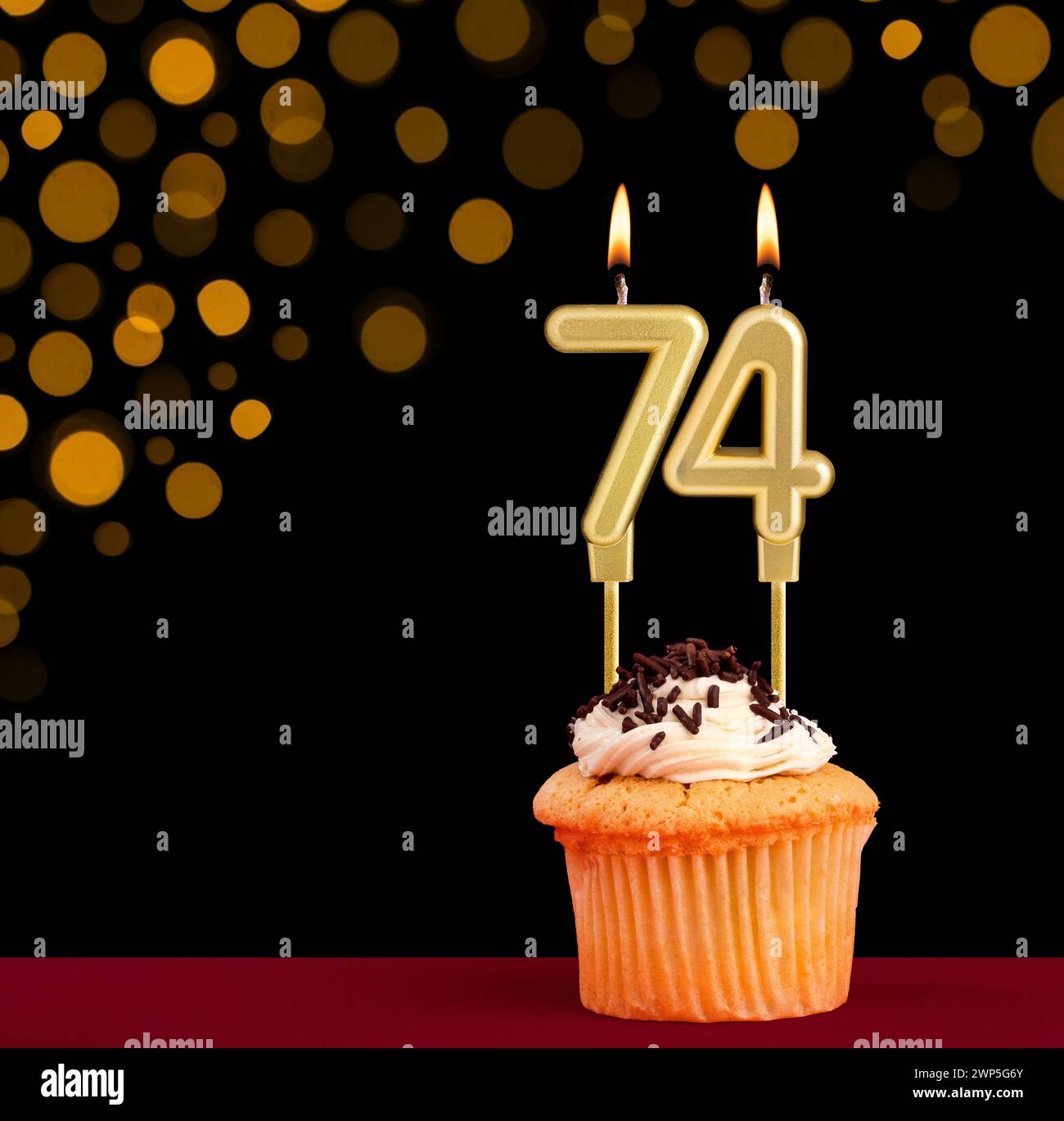Birthday candle with cupcake - Number 74 on black background with out ...