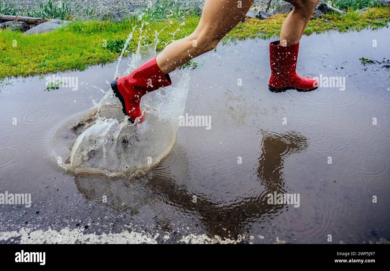 Female athlete running through puddle Stock Photo - Alamy