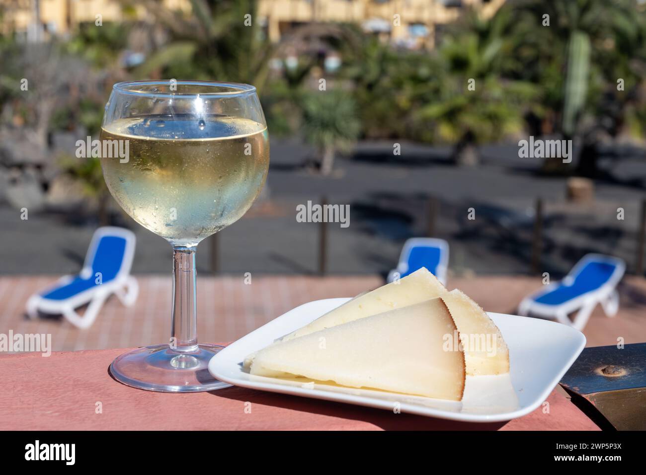 Spanish hard manchego, cow, sheep and goat cheese, glass of cold white ...