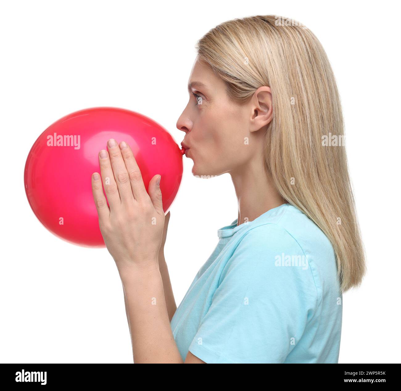 Woman blowing up balloon on white background Stock Photo - Alamy
