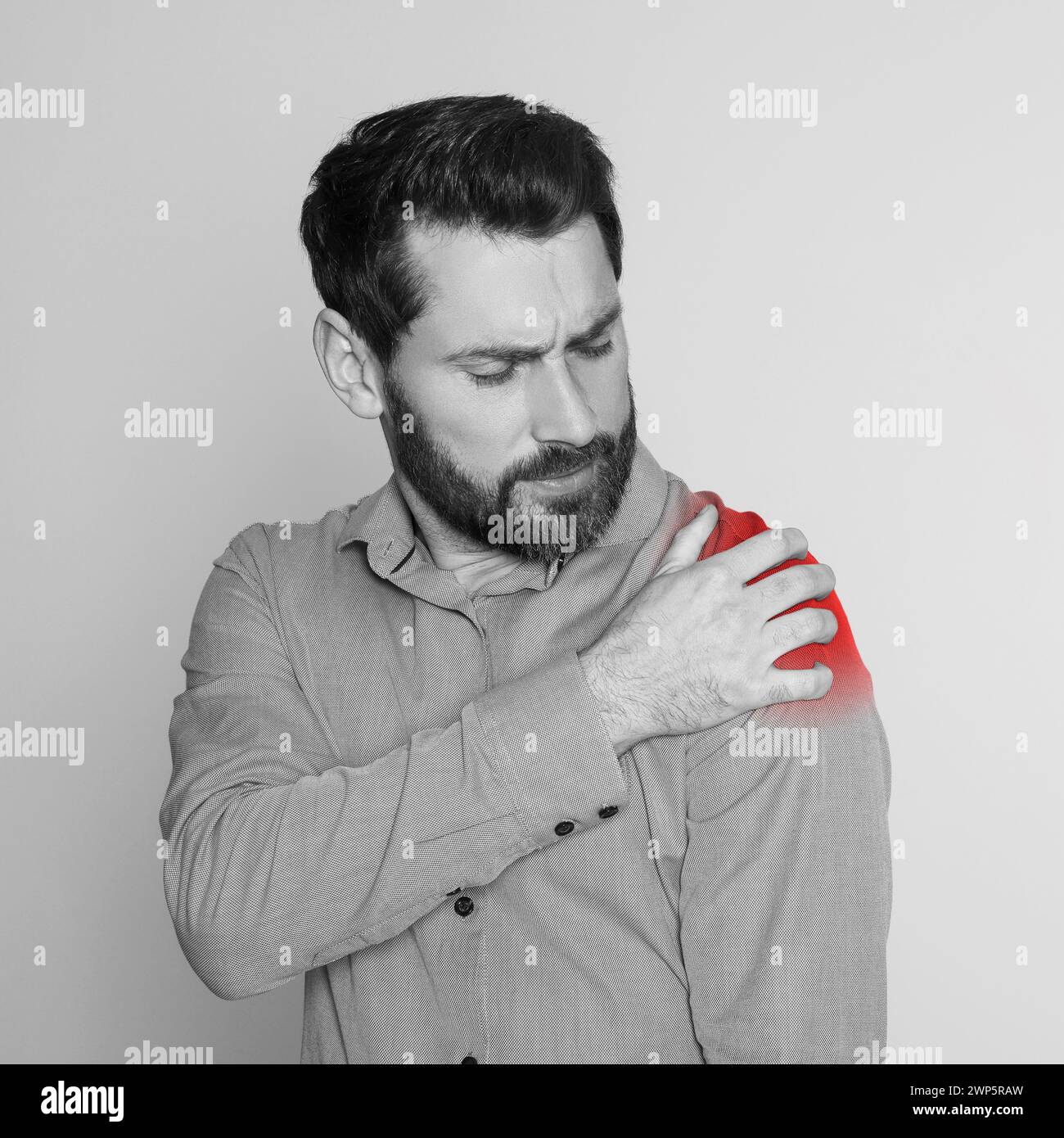 Man suffering from rheumatism on light background. Black and white ...