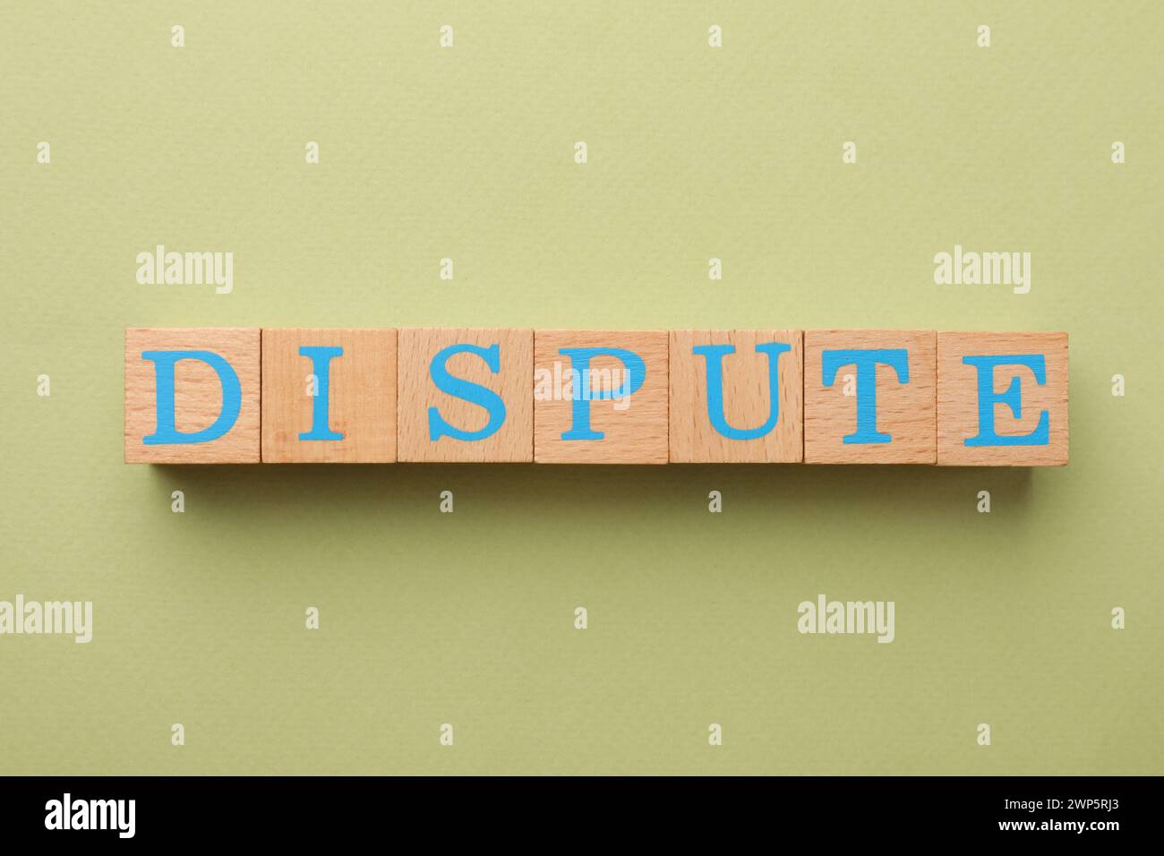 Cubes with word Dispute on light green background, top view Stock Photo ...