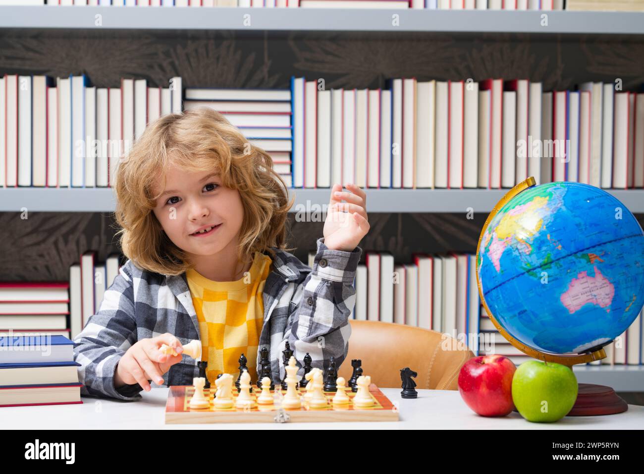 Child play chess in classroom at school. Kid thinking about chess. The ...