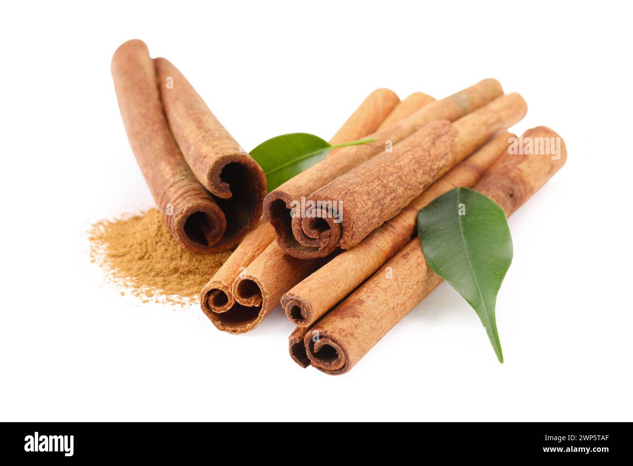Dry aromatic cinnamon sticks, powder and green leaves isolated on white ...