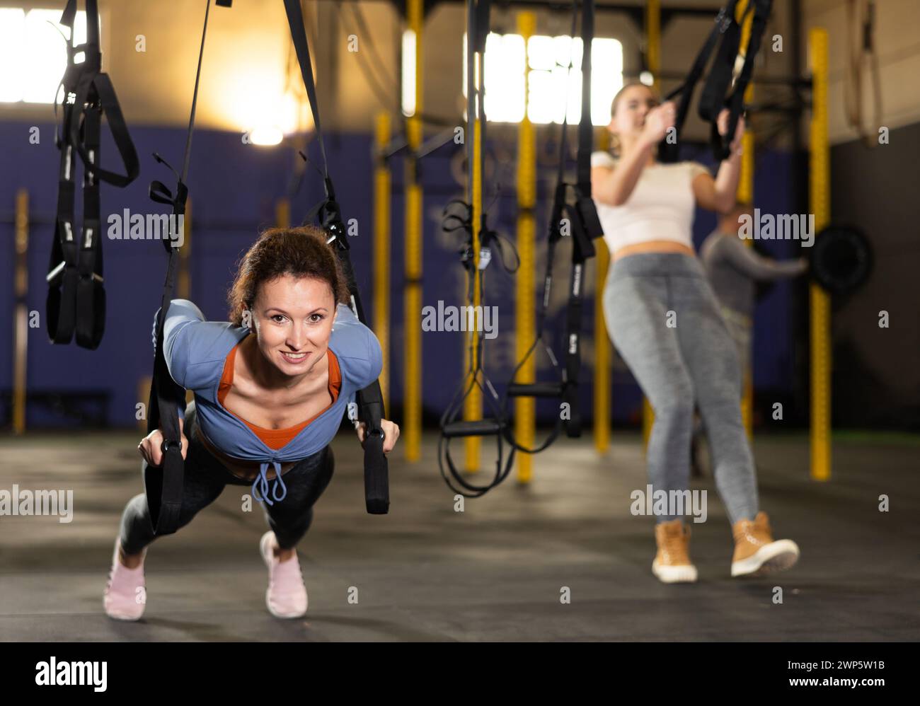 Woman exercising suspension straps hi-res stock photography and images ...