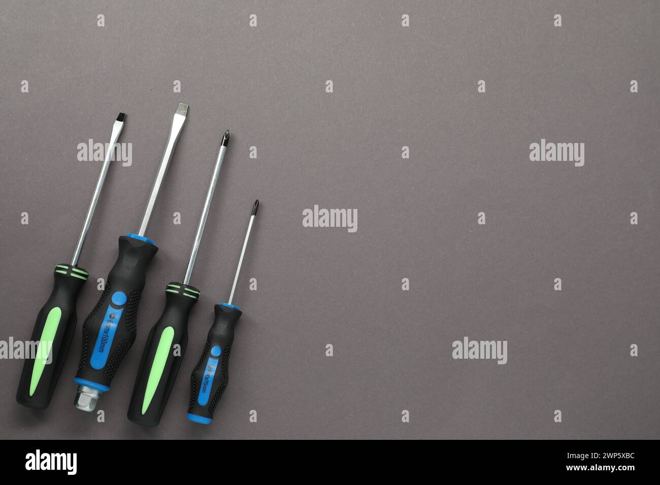 Set of screwdrivers on grey background, flat lay. Space for text Stock ...