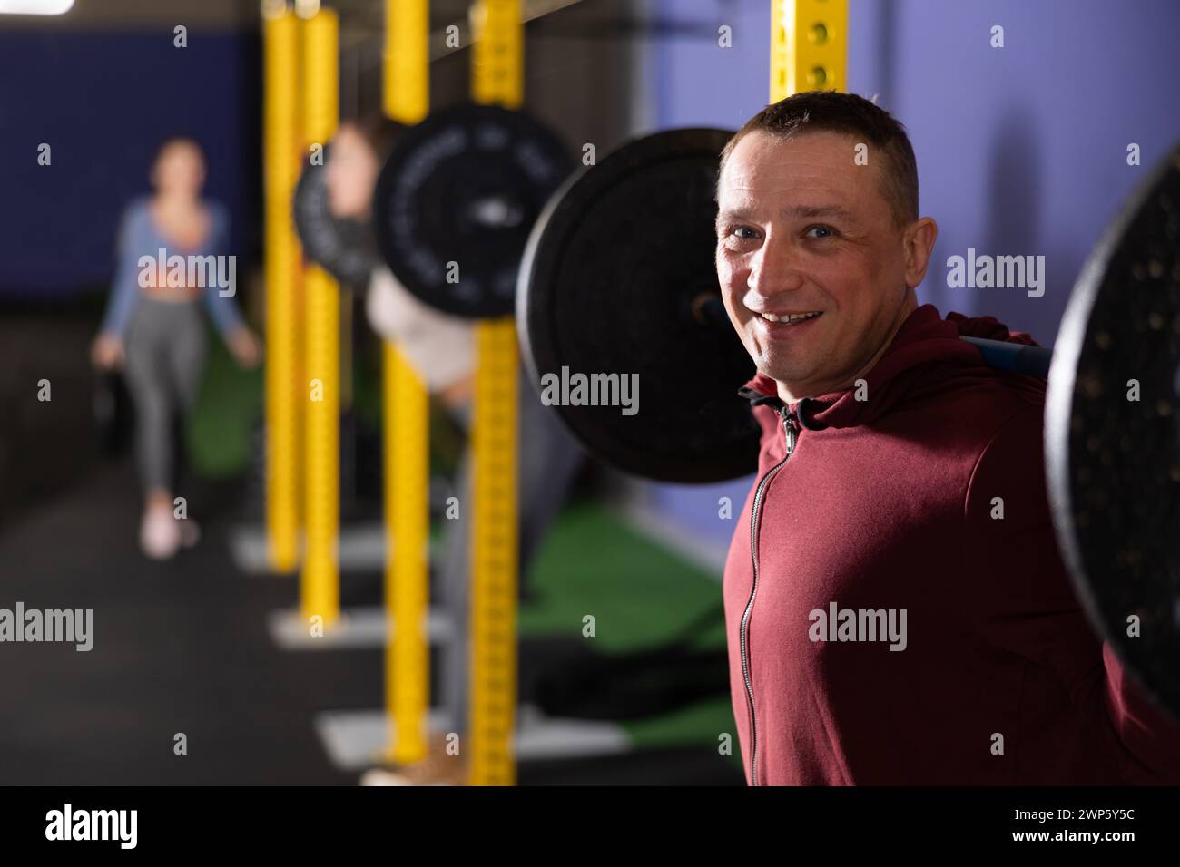 Adult male bodybuilder performing strength and endurance exercises ...