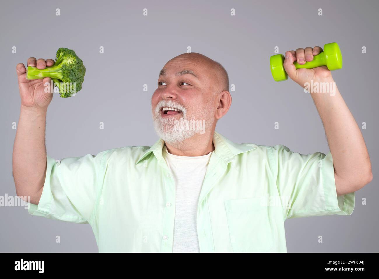 Healthy Senior. Healthy food. Power old mature man hold dumbbell and ...