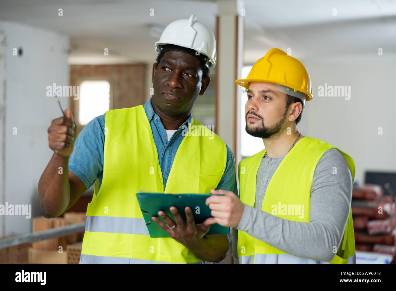 Two engineers discussing work in apartment Stock Photo - Alamy