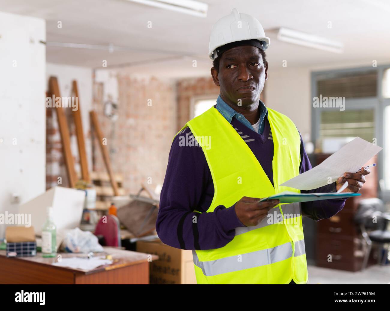 Responsible engineer with papers conducting inspection of construction ...