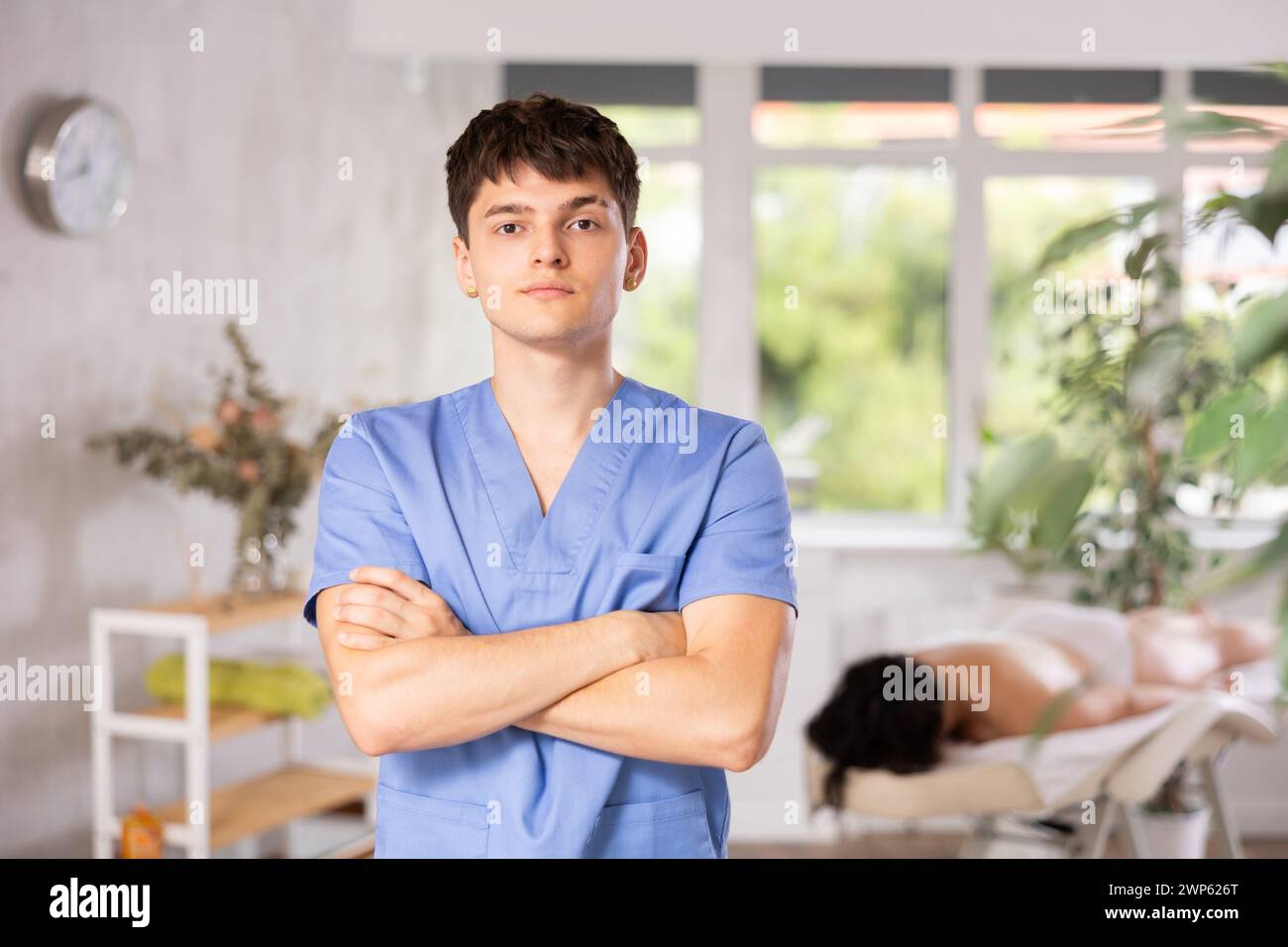 Friendly male massage therapist invites you to visit spa Stock Photo ...