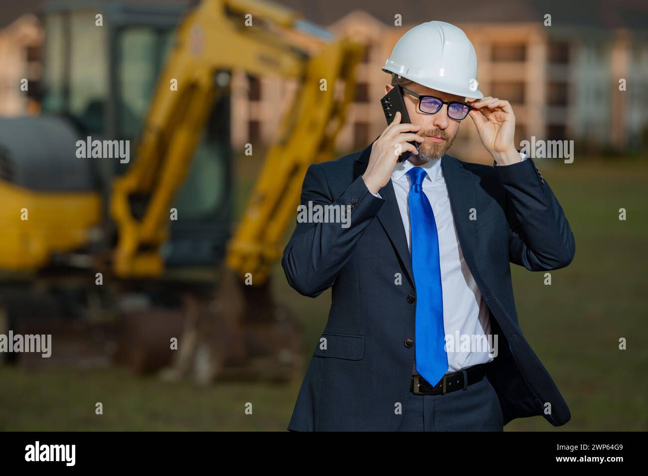 Successful construction business owner. Construction worker in suit and ...