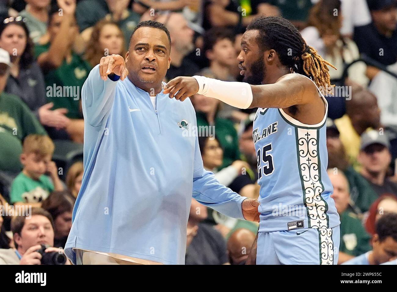 Tulane head coach Ron Hunter calls a play with guard Jaylen Forbes (25 ...