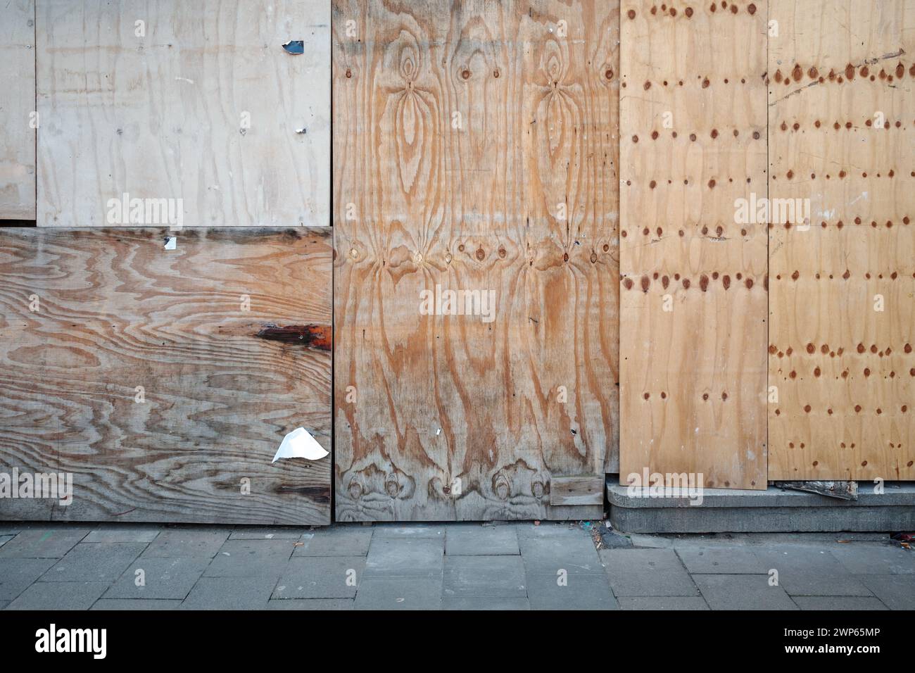 A detailed view of a sidewalk bordered by a diverse patchwork of ...