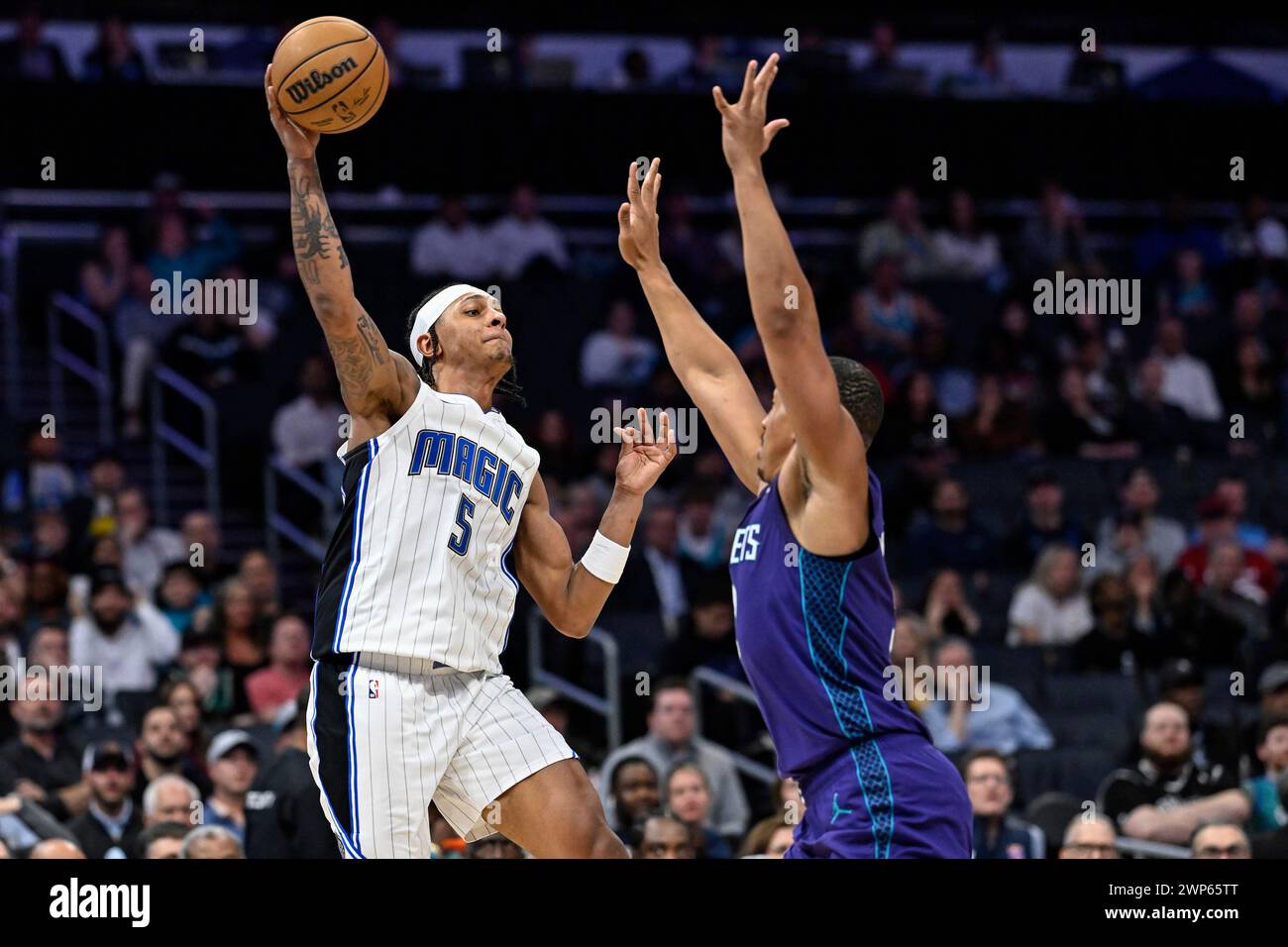 Orlando Magic forward Paolo Banchero (5) looks to pass the ball away from Charlotte Hornets ...
