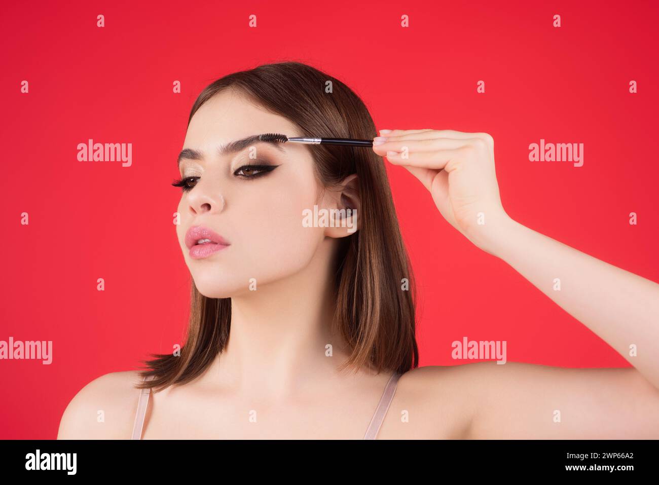 Beautiful woman with dark eyebrows hold eyebrow brush. Eyebrows ...