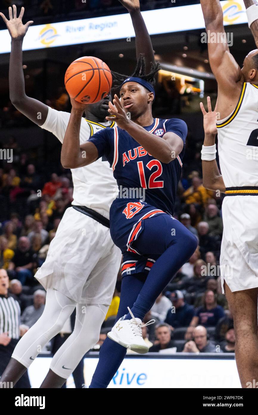 Auburn's Denver Jones, center, passes the ball from between Missouri's ...