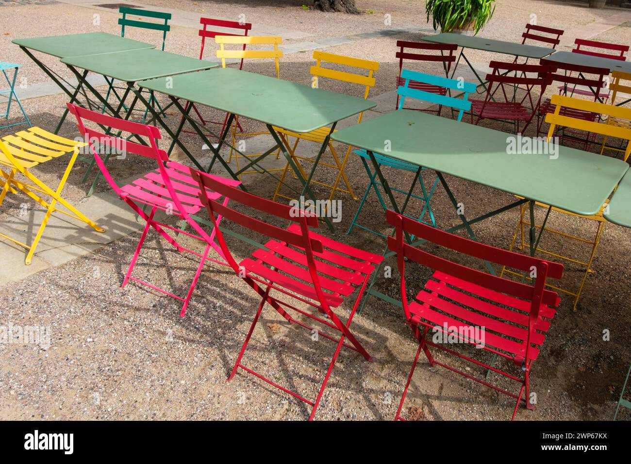 Folding seats in a rainbow of colors - red, blue, yellow and green are ...