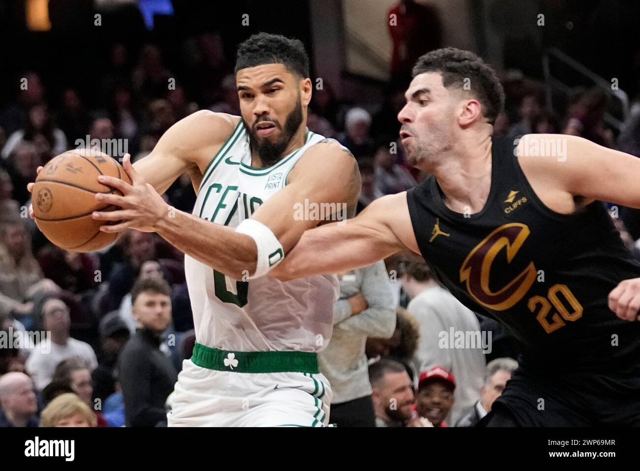Boston Celtics forward Jayson Tatum, left, drives past Cleveland Cavaliers forward Georges Niang ...