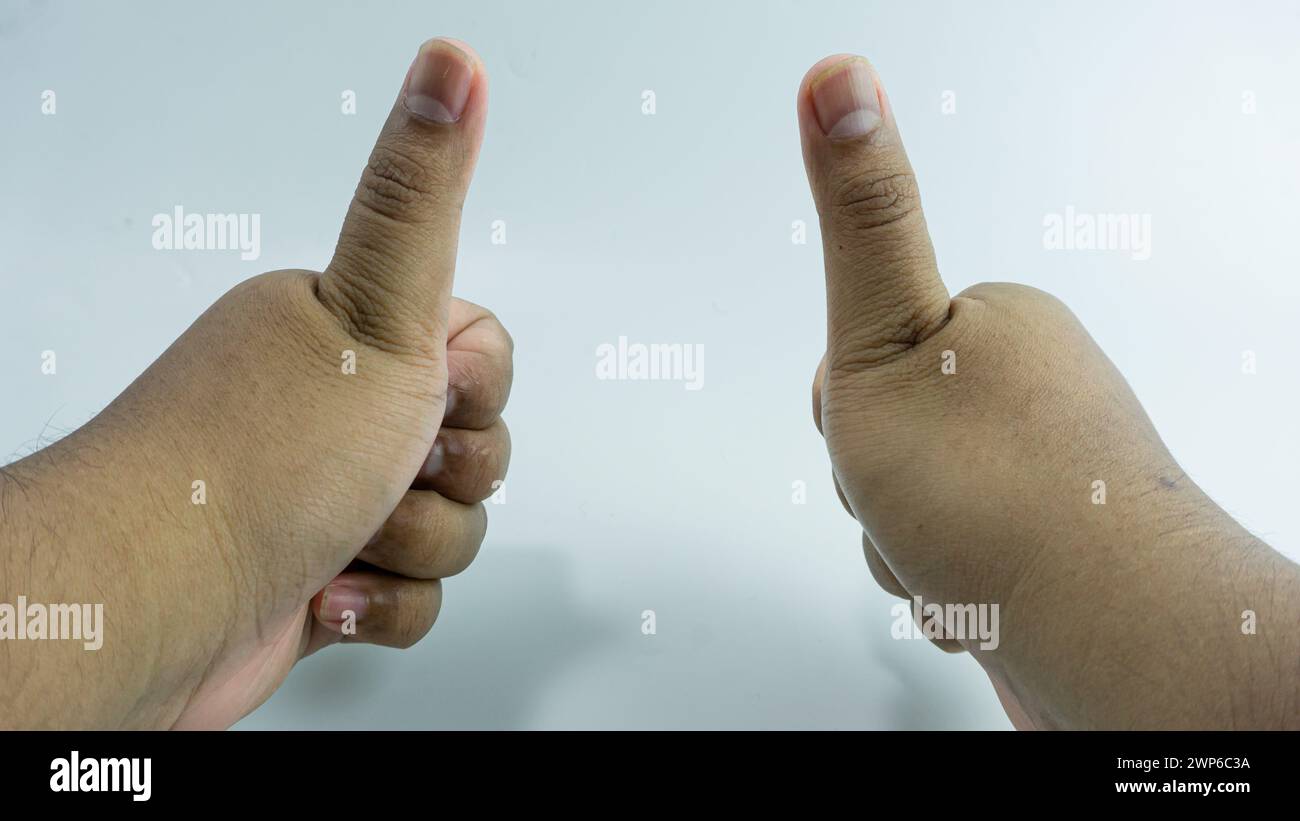 Two-handed pose with thumbs up isolated on white background Stock Photo ...