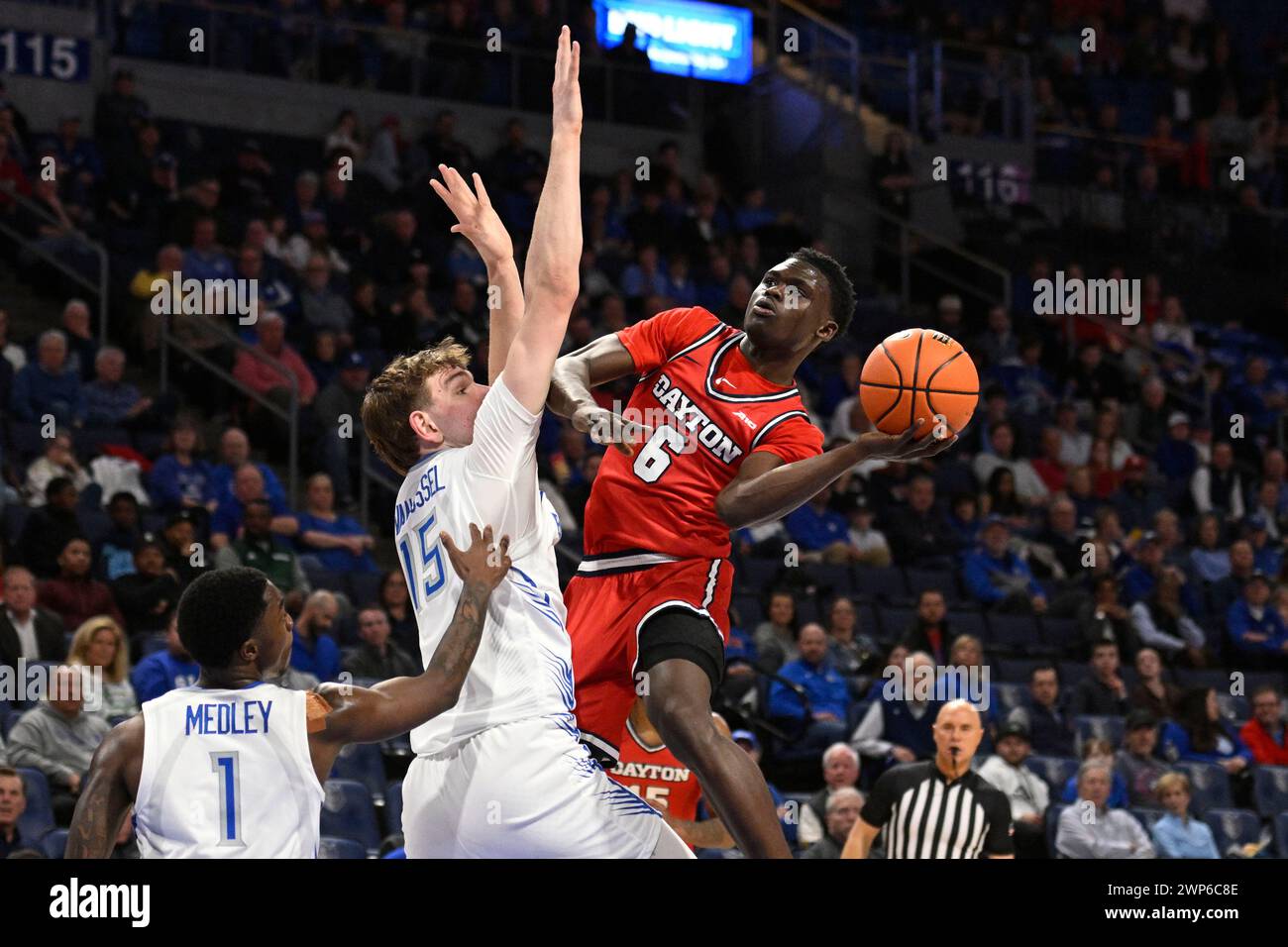 Dayton's Enoch Cheeks, right, goes up for a shot against Saint Louis ...