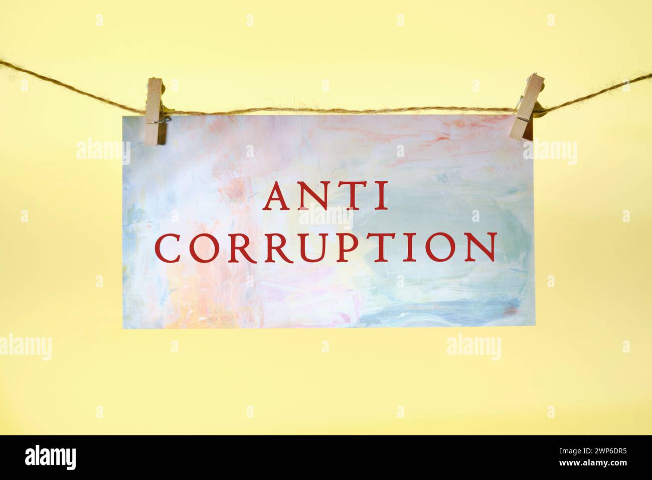 Anti corruption text written on colored paper on a rope in front of a ...