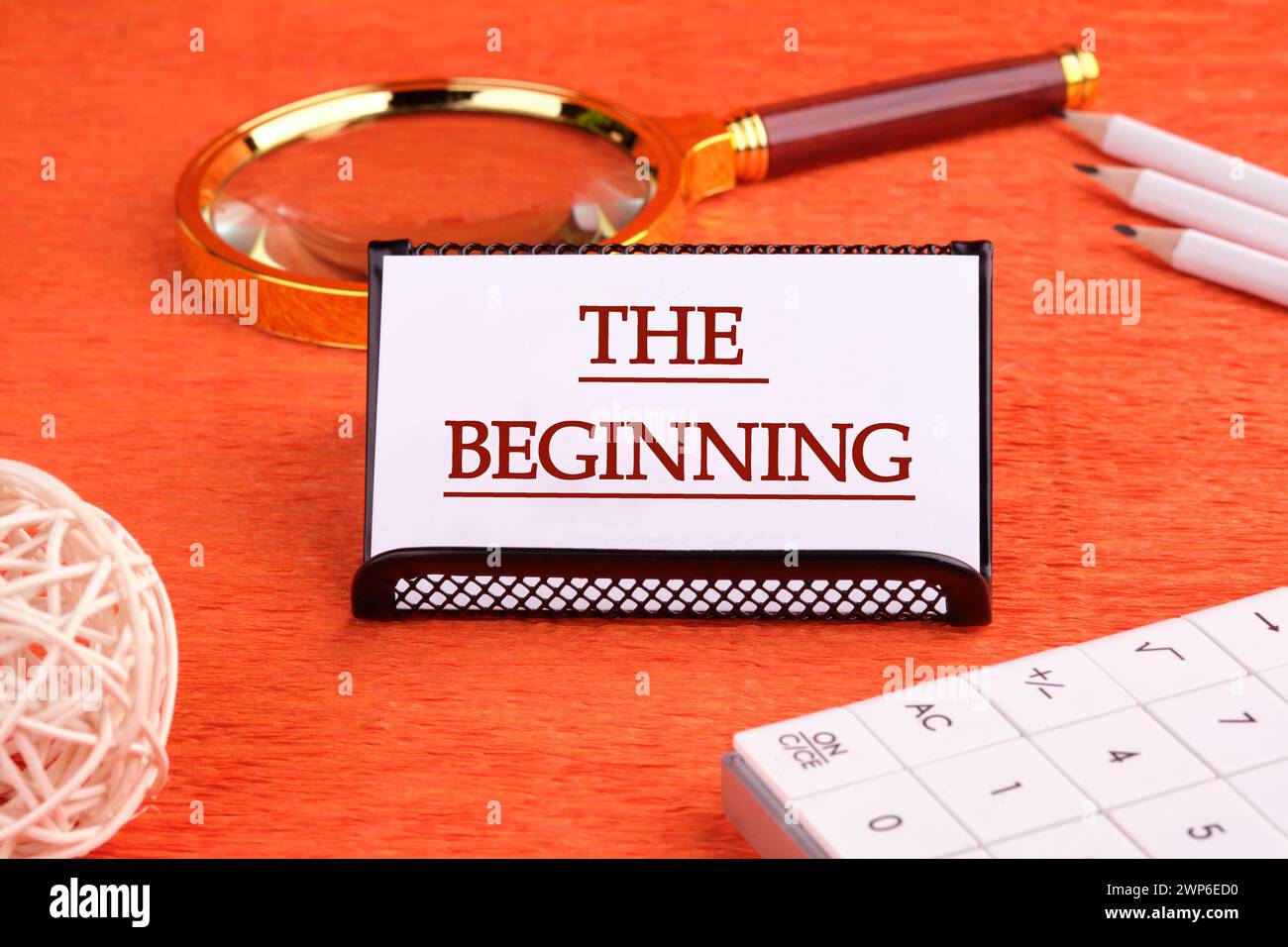 The beginning text written on a white business card on a stand on an ...