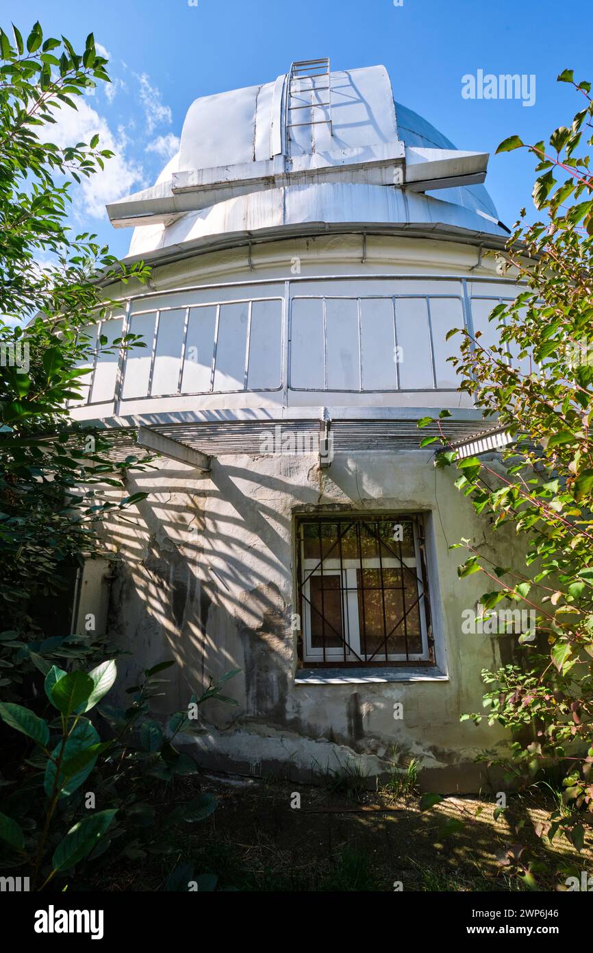 Exterior view of the curved doors of a small, white observatory ...