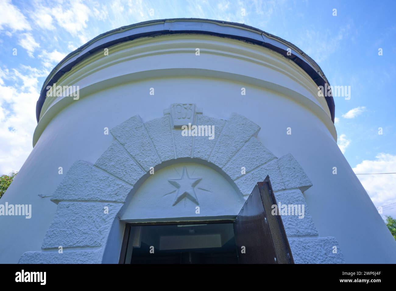 Exterior view of one of the small, white observatory buildings. At the ...