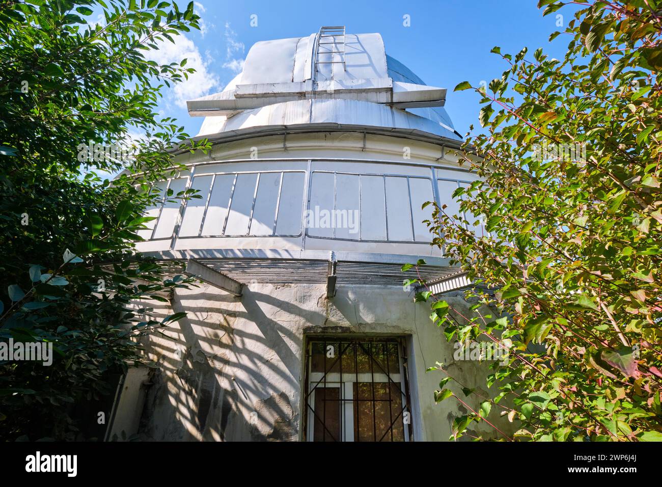 Exterior view of the curved doors of a small, white observatory ...
