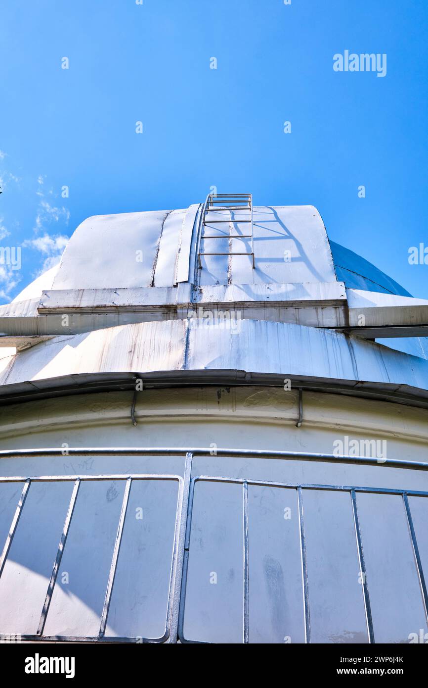 Exterior view of the curved doors of a small, white observatory ...
