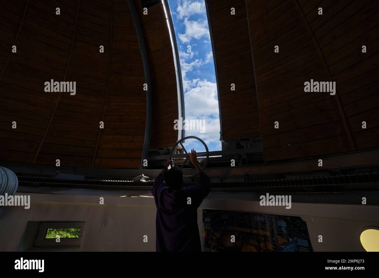 View of a worker opening the curved doors to the sky in one of the ...
