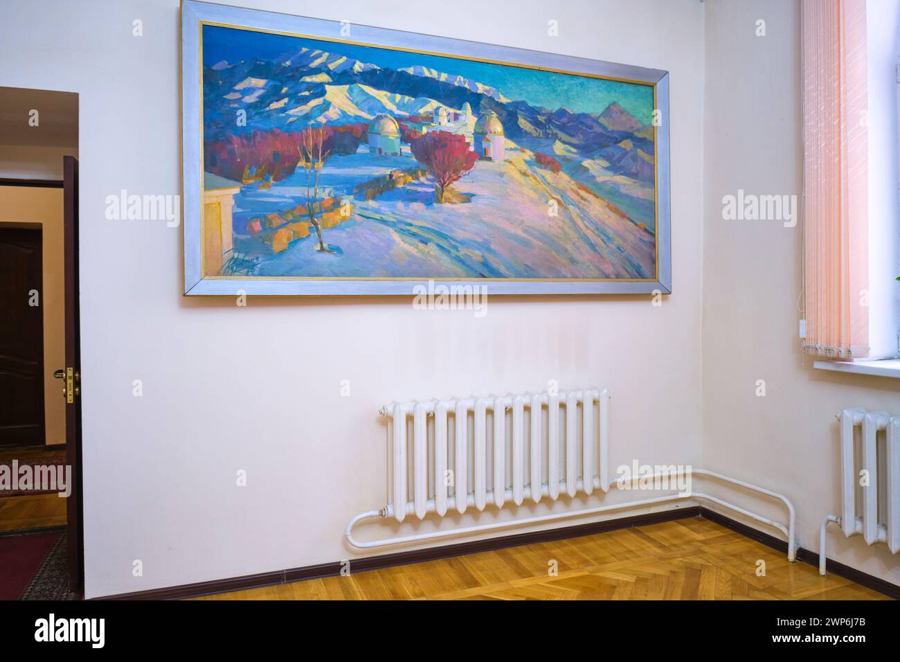 In the office lobby, a painting of the complex during winter with snow ...