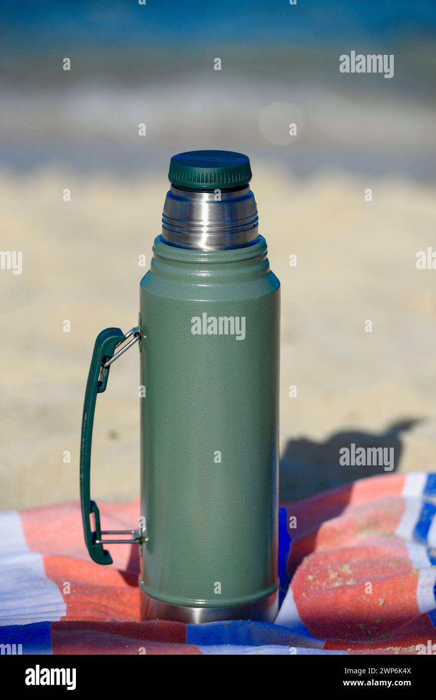 Authentic green Stanley Thermos on the beach in summer Stock Photo - Alamy