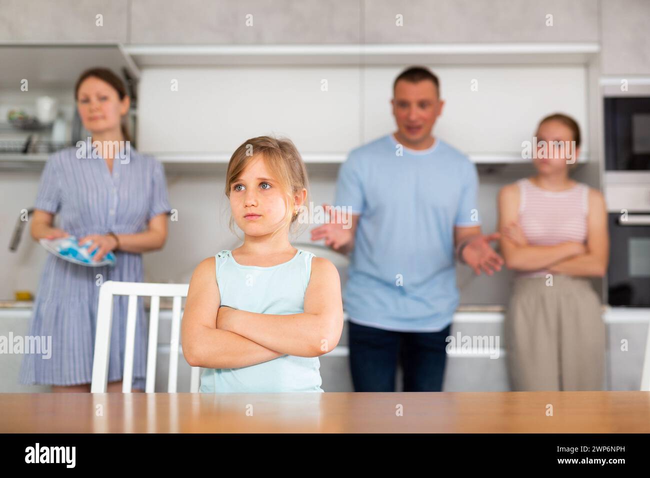 At kitchen parents scold standing daughter for bad behavior, mother ...