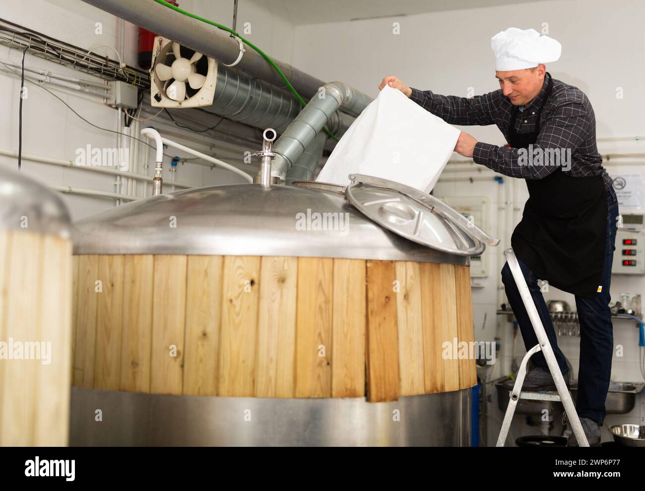Man brewmaster pouring beer component into tank Stock Photo - Alamy Man brewmaster pouring beer component into tank Stock Photo - Alamy