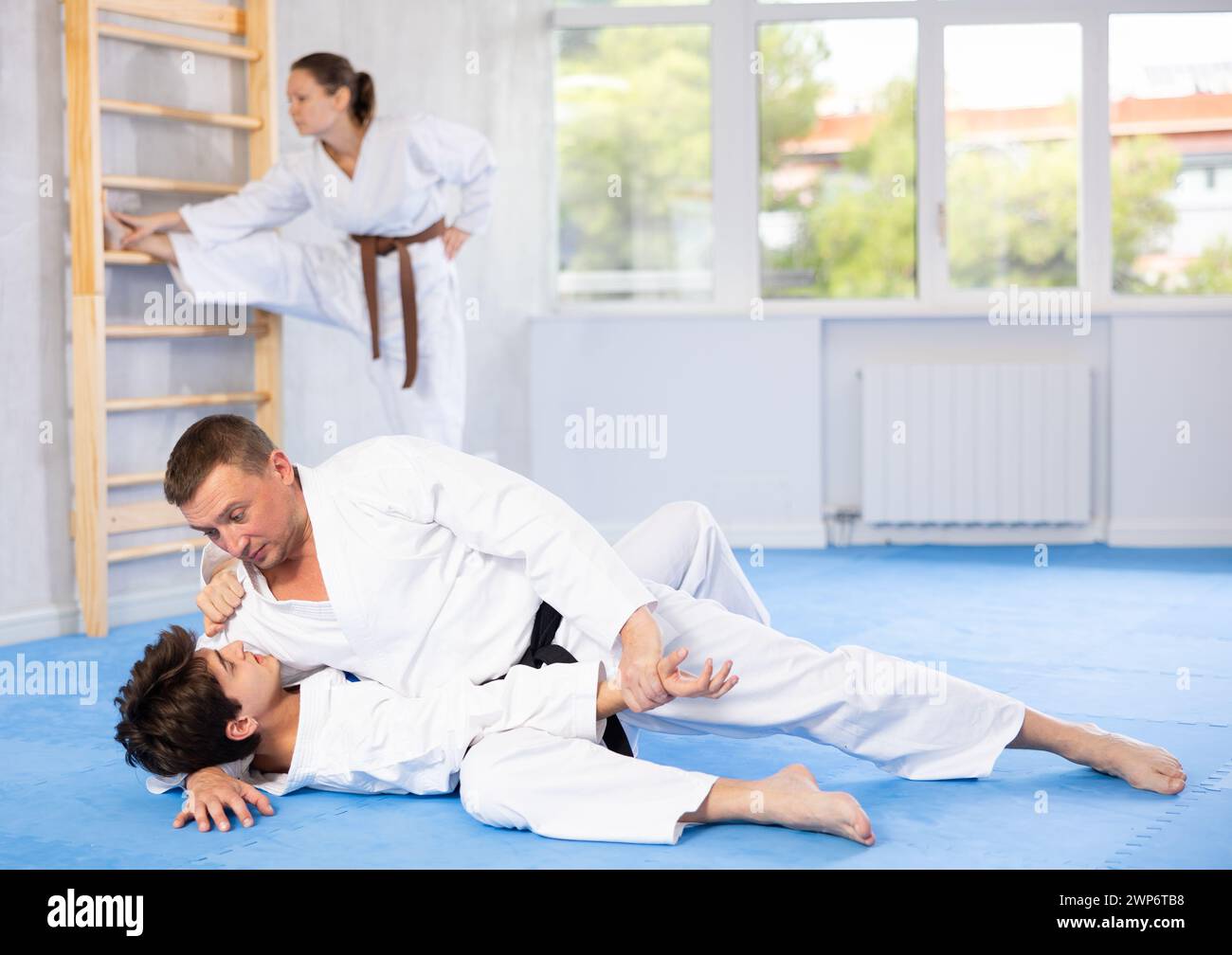 Male athletes in pair conduct training battle in oriental fighting ...